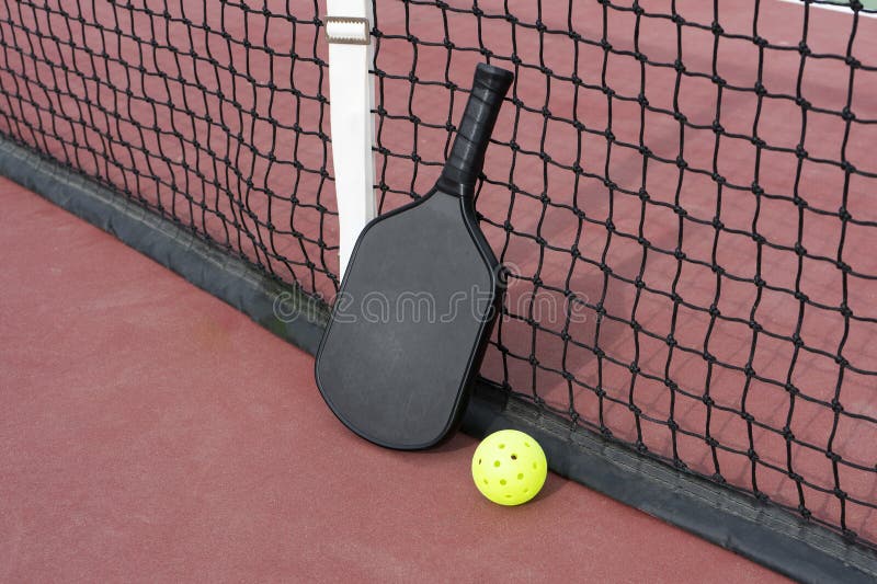 Pickleball Paddle and Ball at Net on Pickleball Court. Stock Photo ...
