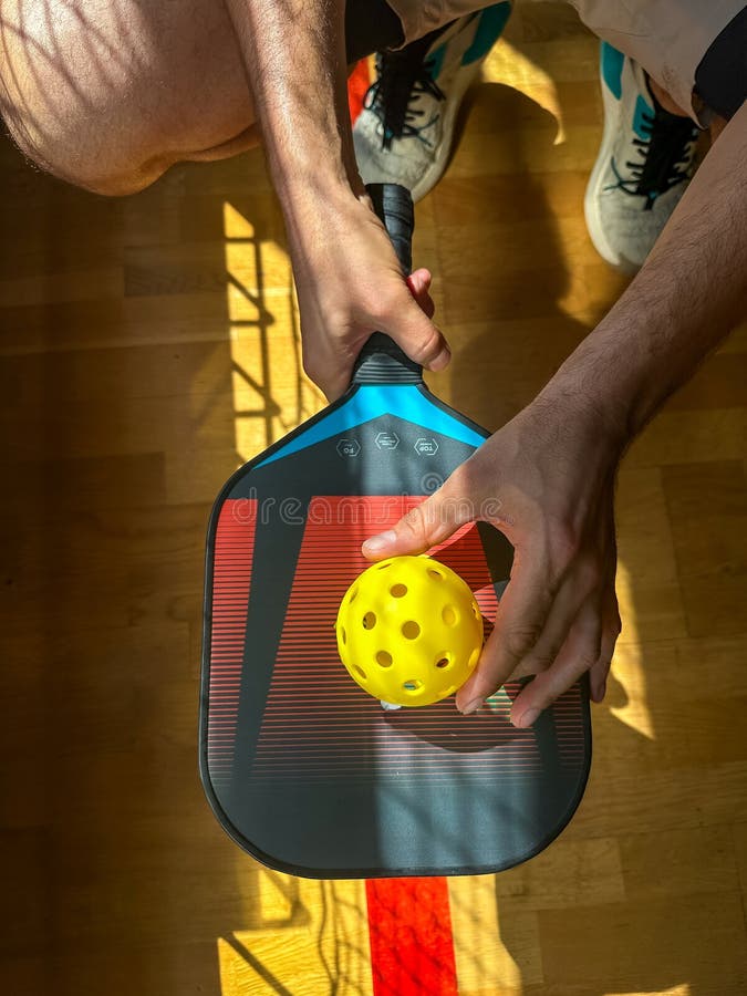 Pickleball Paddle with Yellow Pickleball with Shadow of Pickleball Net ...
