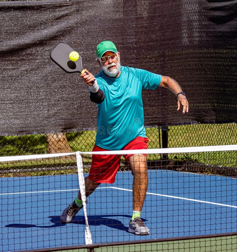 Pickleball Player Leans in To Strike a Sharp Volley Stock Photo - Image ...