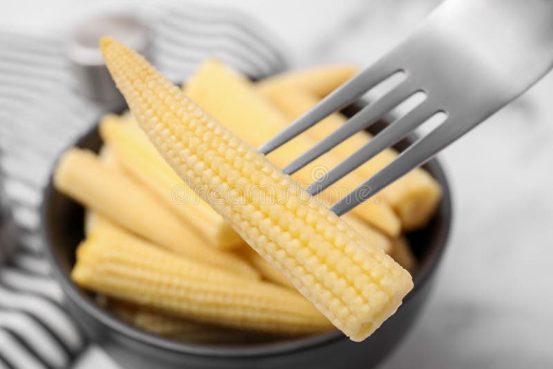 Pickled Baby Corn on Fork at Table, Closeup Stock Photo - Image of ...