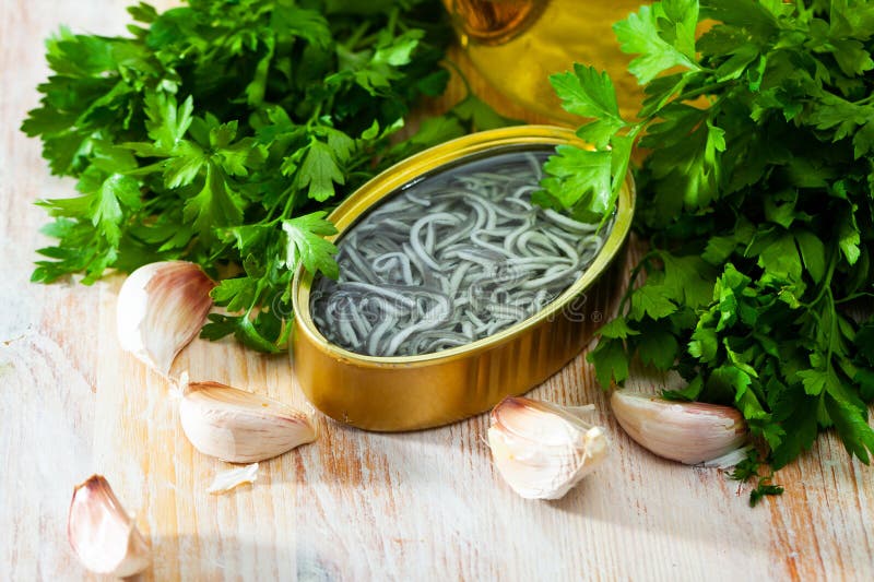 Pickled Eels in Open Tin Can with Garlic at Table Stock Photo - Image ...