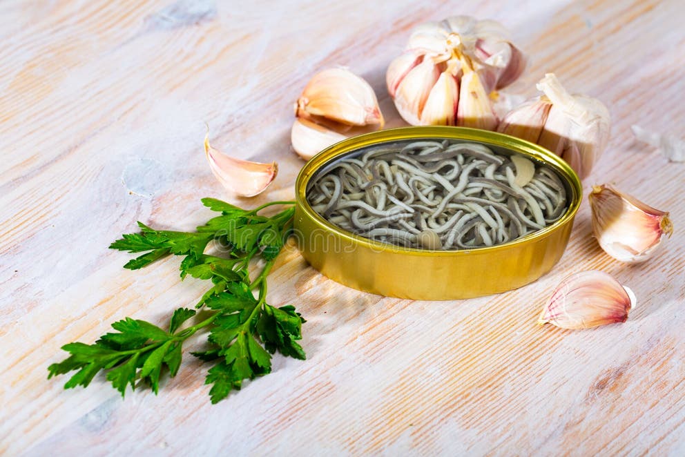 Pickled Eels in Open Tin Can with Garlic at Table, Nobody Stock Photo ...
