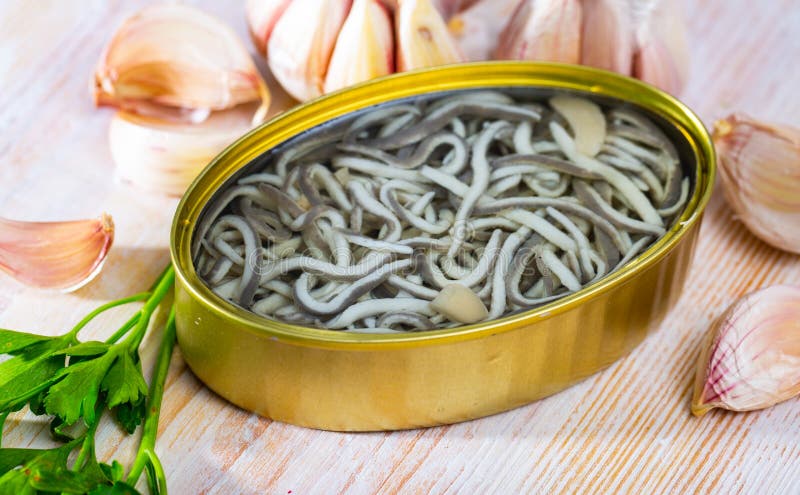 Pickled Eels in Open Tin Can with Garlic at Table Stock Photo - Image ...