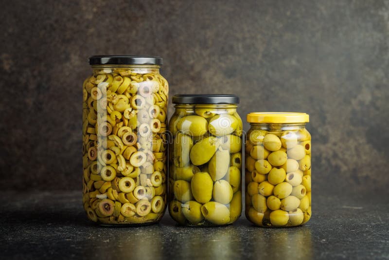 Pickled Green Olives in Brine in Jar on Black Table Stock Photo - Image ...