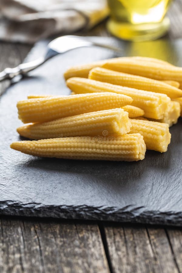 Pickled Young Baby Corn Cobs on Black Stone Cutting Board Stock Image ...