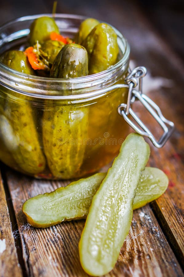 Pickles with Garlic in Glass Jar on Rustic Wooden Background Stock ...