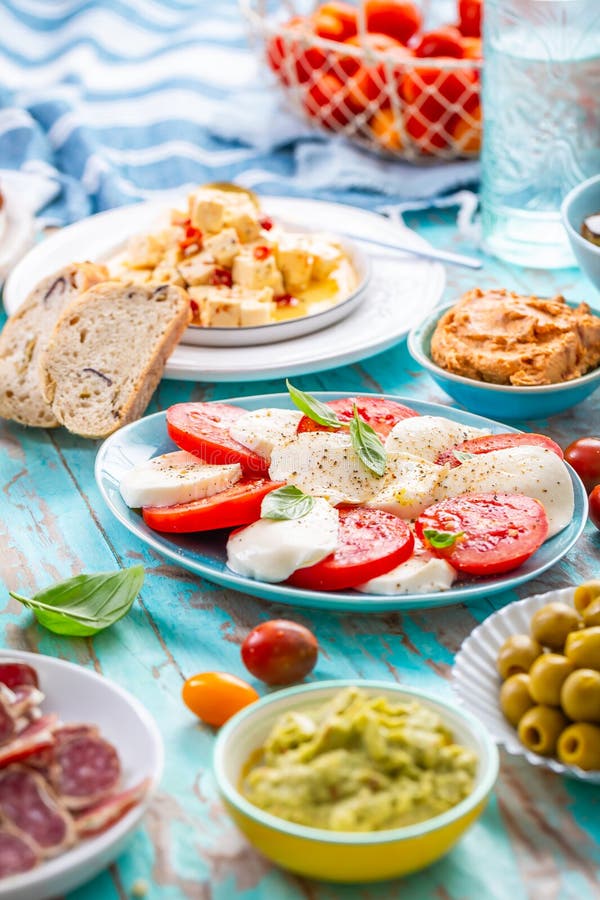 Picnic Table with Assorted Appetizers, Raw Vegetables, Cheese, Dips ...
