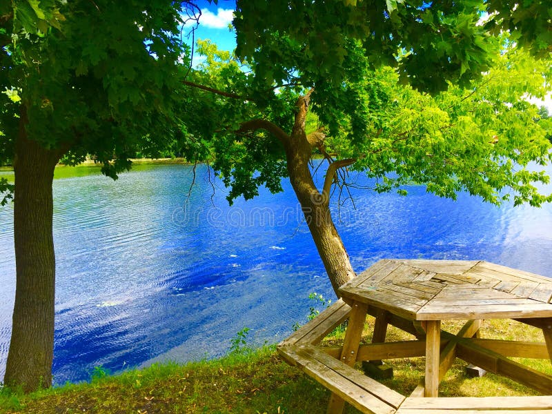 Picnic Table by a River stock photo. Image of sunny, river - 75108056