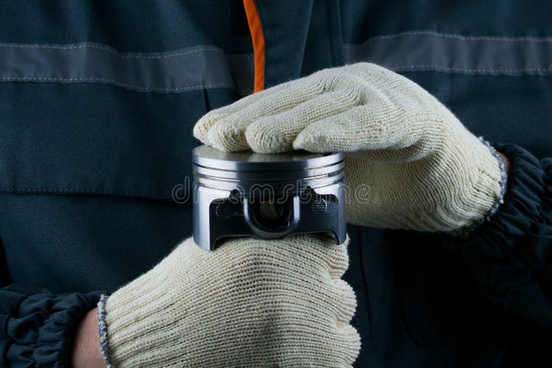 Mechanic Holding Piston from Engine on Dark Background Stock Photo ...