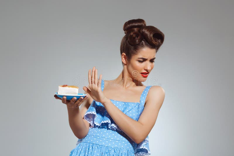 Picture of Beautiful Pin-up Girl Refusing Eating Cake at Studio Stock ...