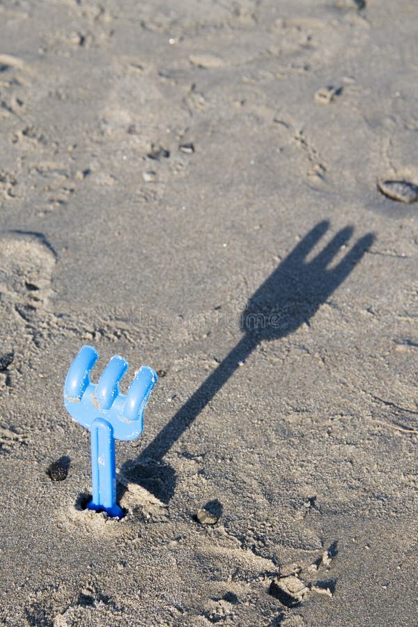 Blue Plastic Rake in the Sand at the Beach in Summer Stock Image ...