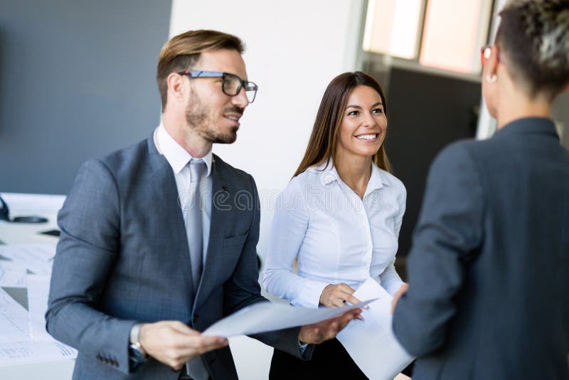 Picture of Business Colleagues Talking in Office Stock Photo - Image of ...
