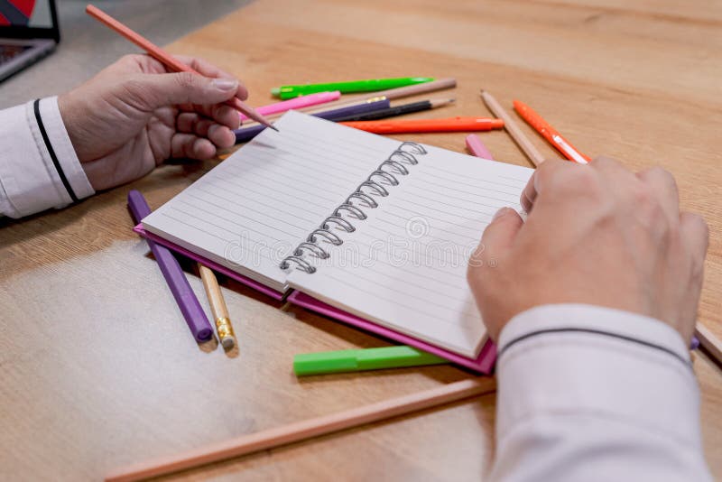 A Picture of a Business Person Holding a Pen and Taking Notes in a ...