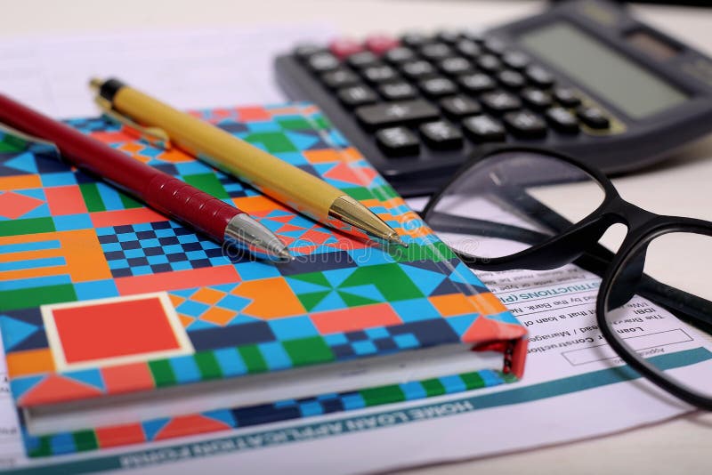 Picture of Calculator, Two Pen, Notebook, Form and Glasses Stock Image ...