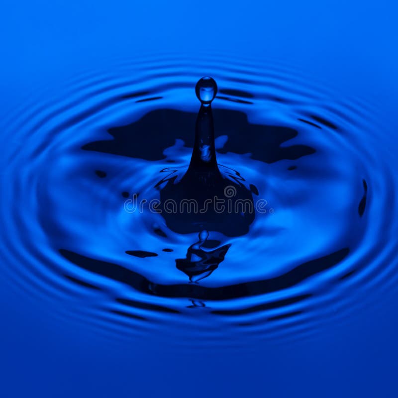 Picture of Clear Water Droplet Dripping into Pool with Stem and Ripples ...