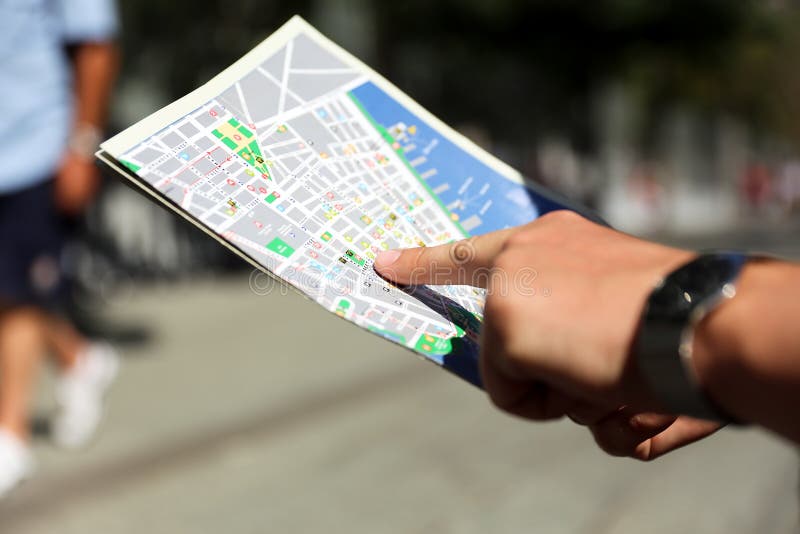 Picture of a Close Up Man is Looking for Directions on the Map Outside ...