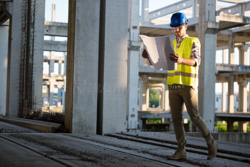 Picture of Construction Site Engineer Looking at Plan Stock Photo ...