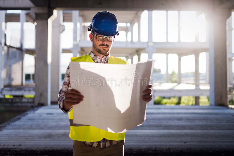 Picture of Construction Site Engineer Looking at Plan Stock Photo ...