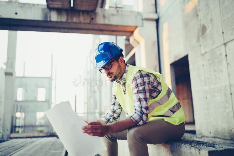 Picture of Construction Site Engineer Looking at Plan Stock Photo ...