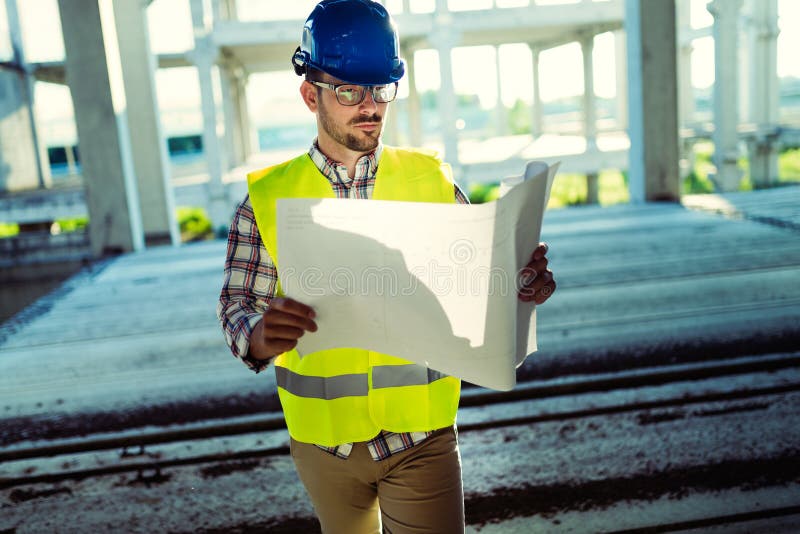 Picture of Construction Site Engineer Looking at Plan Stock Photo ...