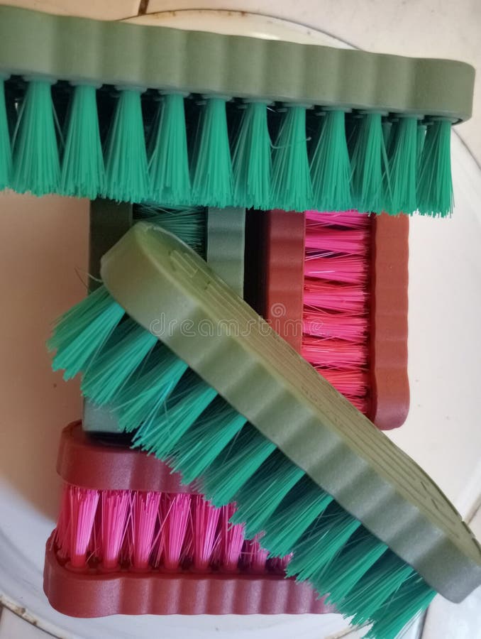 Picture of Five Green and Red Clothes Brushes that Can Be Used at Home ...