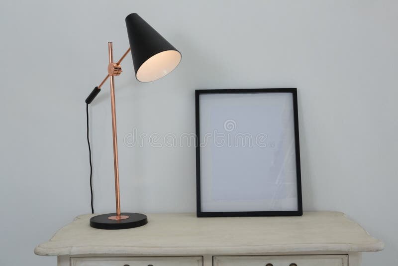 Picture Frame and Illuminated Lamp on Table Stock Photo - Image of ...