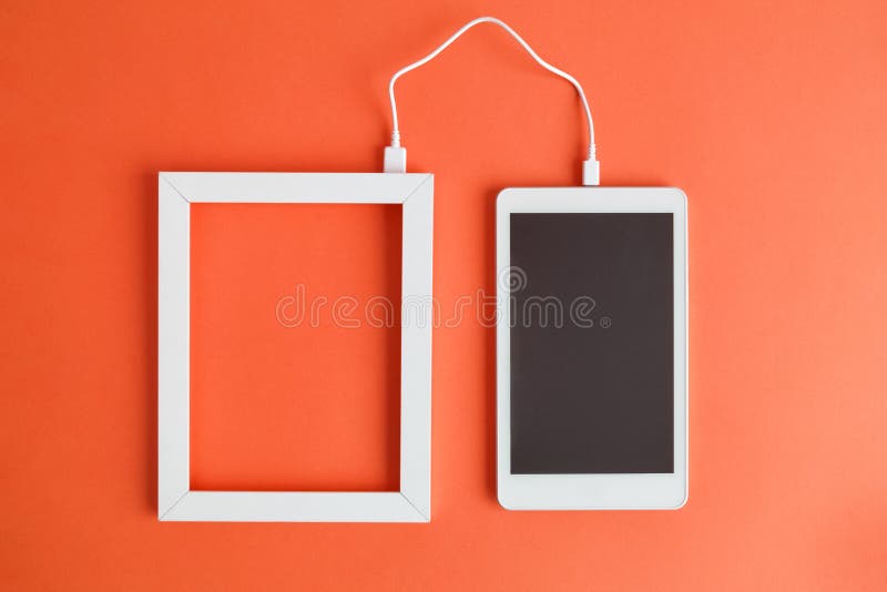Picture Frame and Tablet Device with Cable on Orange. Space for Copy ...