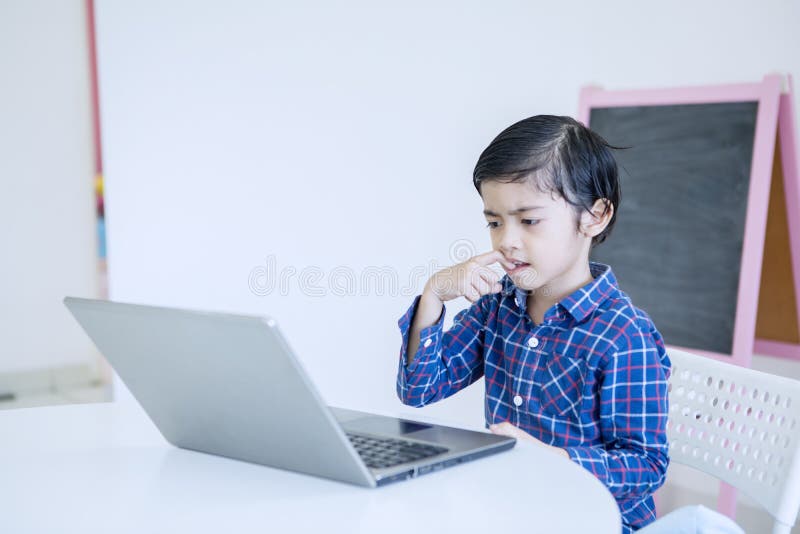 Little Boy Thinking Something during Using a Laptop Stock Image - Image ...