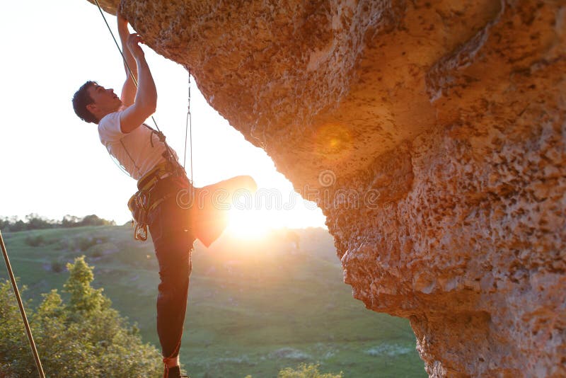 Picture of Man Clambering Over Rock. Stock Photo - Image of alpinists ...