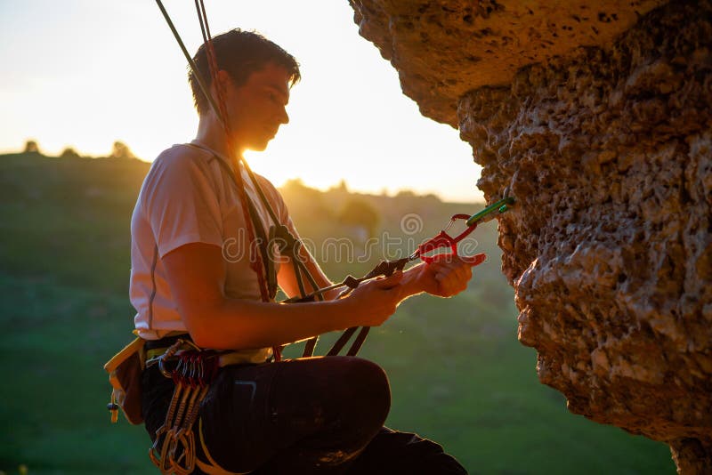 Picture of Man Clambering Over Rock. Stock Image - Image of hanging ...