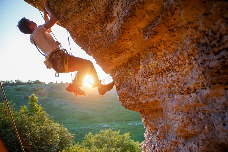 Picture of Man Clambering Over Rock. Stock Photo - Image of flare ...