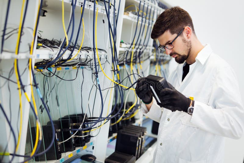 Picture of Network Technician Testing Modems in Factory Stock Image ...