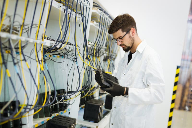 Picture of Network Technician Testing Modems in Factory Stock Photo ...