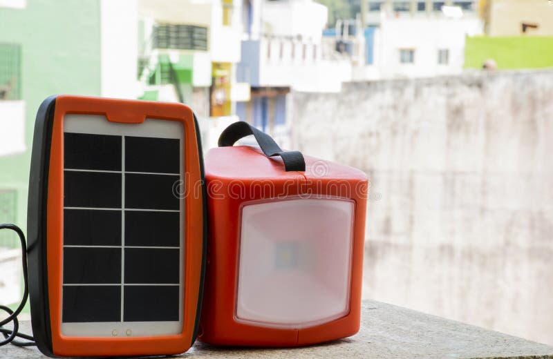 Picture of a Orange Color Solar LED Light with Mini Solar Panel. Kept ...