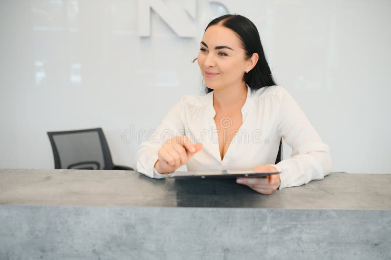 Picture of Pretty Receptionist at Work. Stock Image - Image of people ...