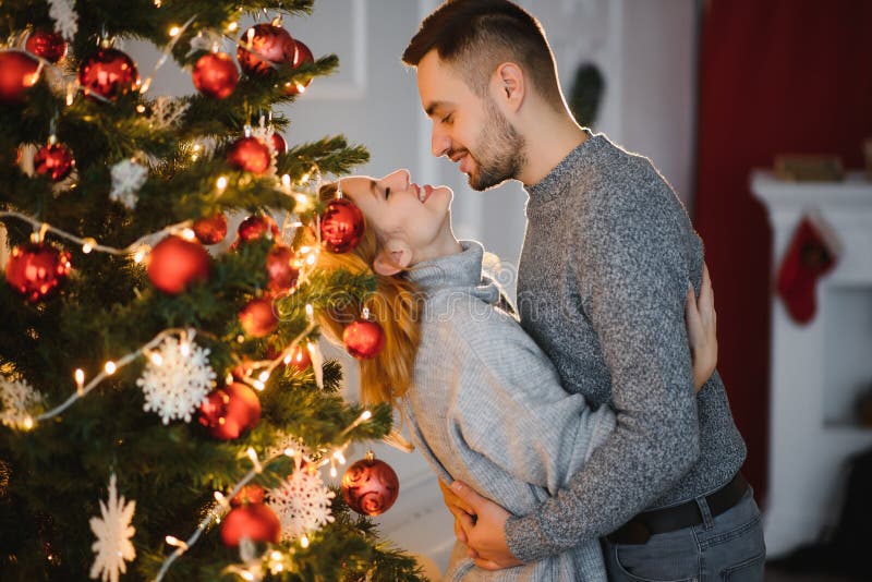 Picture Showing Young Couple Hugging Over Christmas Tree. Stock Photo ...