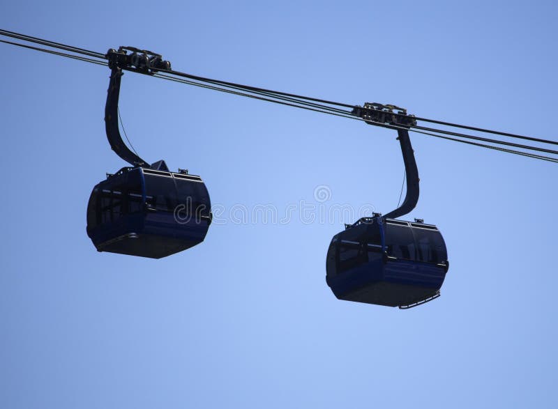 The Picture Shows a Modern Cable Car with Two Cabins Going in Different ...