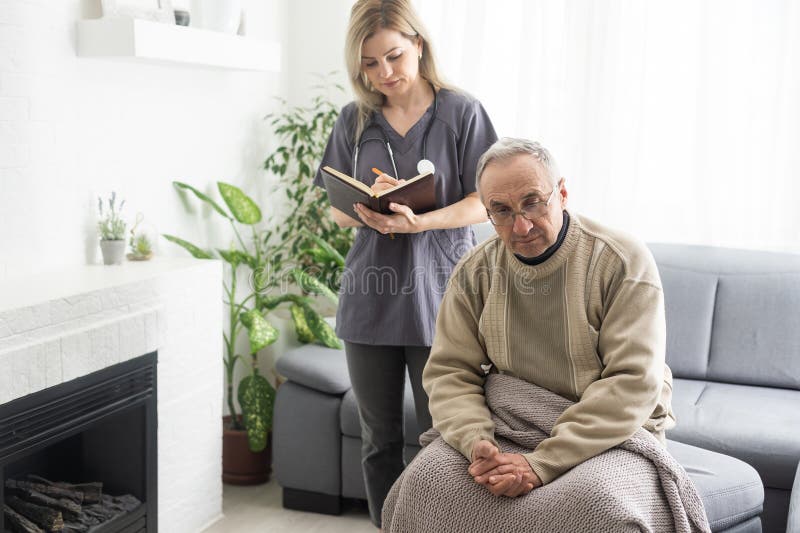 Picture of Smiling Nurse Assisting Senior Man Stock Image - Image of ...