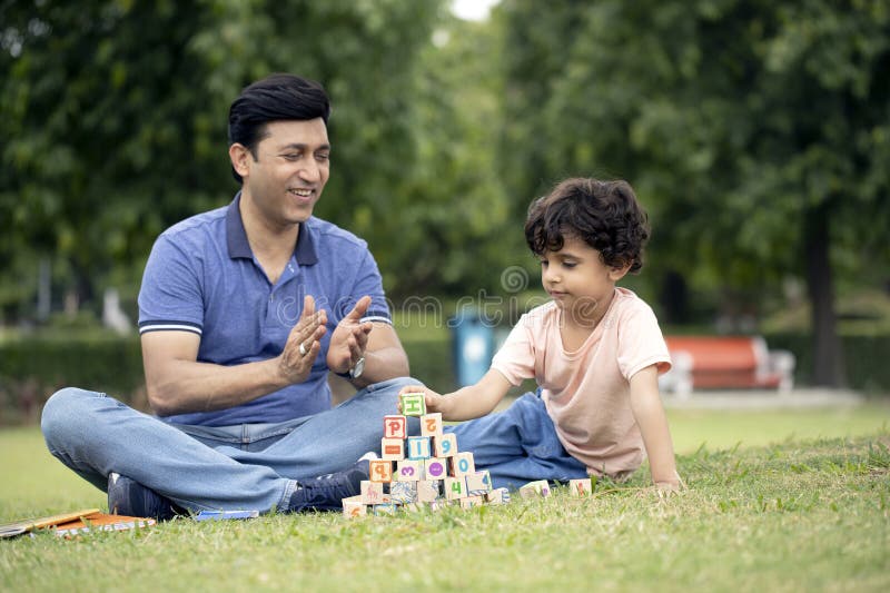 Picture of Son Building Block Tower & Dad Clapping His Hands Stock ...
