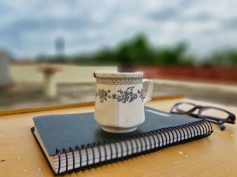 Picture of a Tea Cup,book and Spectacles Kept on a Table Stock Image ...