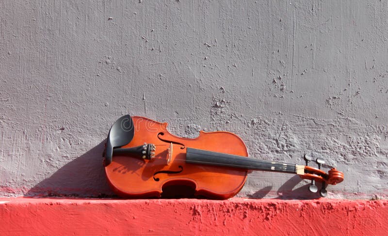 Old violin on rough wall stock photo. Image of arts - 284256446