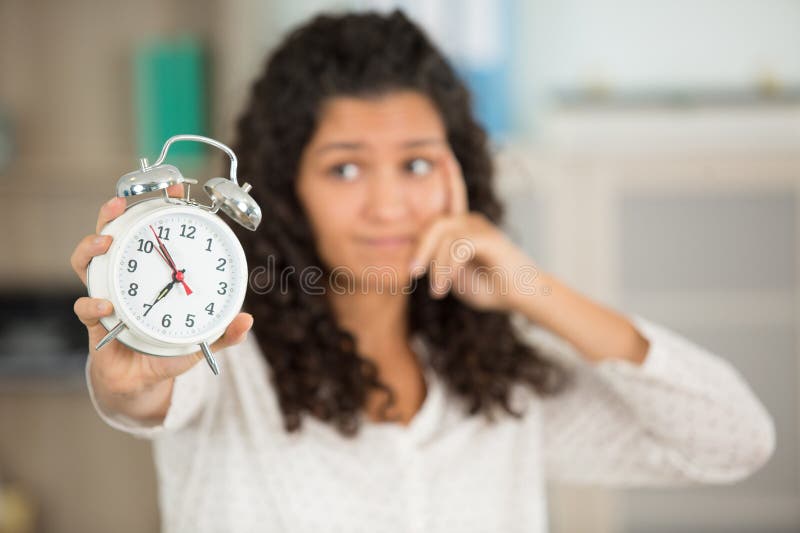Picture Woman Holding Alarm Clock and Thinking Stock Photo - Image of ...