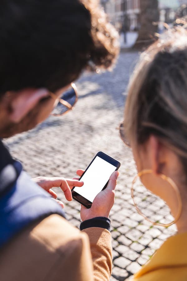 Picture of Young Couple Using Phone To Find Way Stock Image - Image of ...