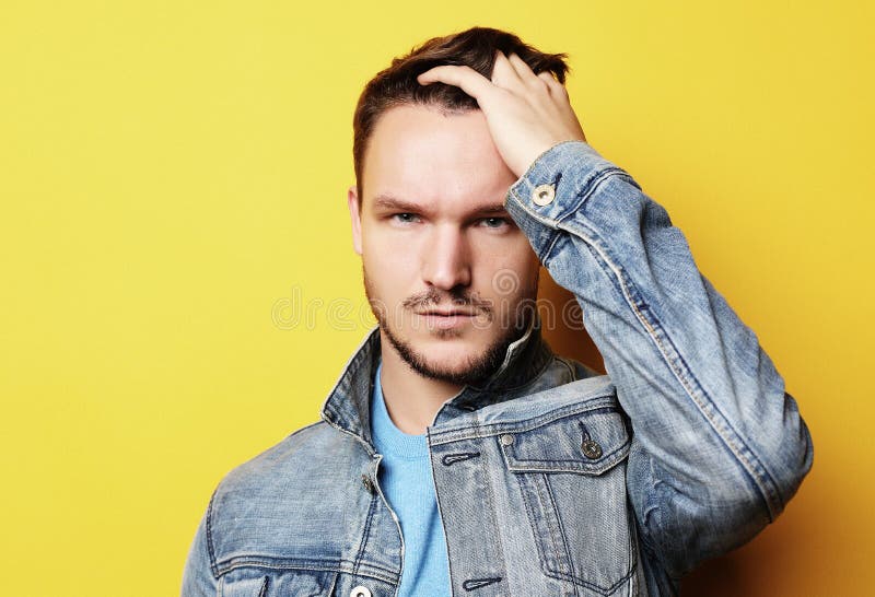 Picture of Young Man Standing Isolated Over Yellow Background. L Stock ... Picture of Young Man Standing Isolated Over Yellow Background. L Stock ...