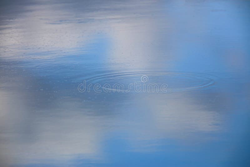 Blue Sky Reflected on the Surface of the Water with the Ripple Stock ...