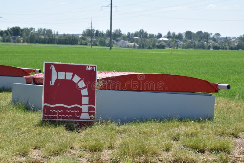 Warning Sign Fire Pond, Hidden in the Grass Stock Photo - Image of fire ...