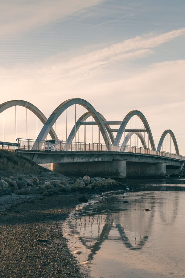Picturesque Arched Bridge Spanning a Tranquil Body of Water at Sunset ...