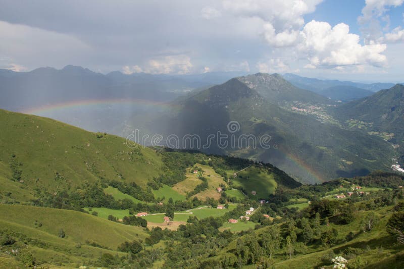 Picturesque Landscape with Rainbow Over Mountains in a Sunny Day Stock ...