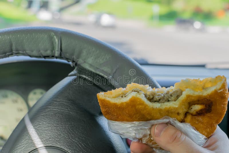 Pie, Belyash in the Hand of the Driver in the Car Stock Photo - Image ...