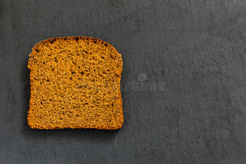 A Piece of Black Rye Bread on a Black Background Stock Image - Image of ...
